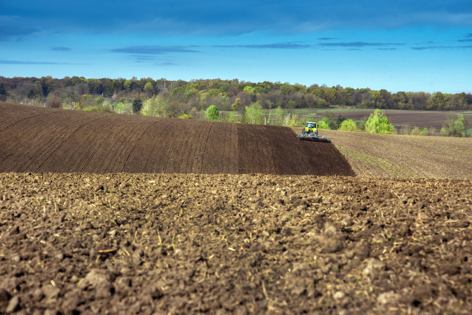 Plowed field close-up, land preparation season, hills farmland under a ...